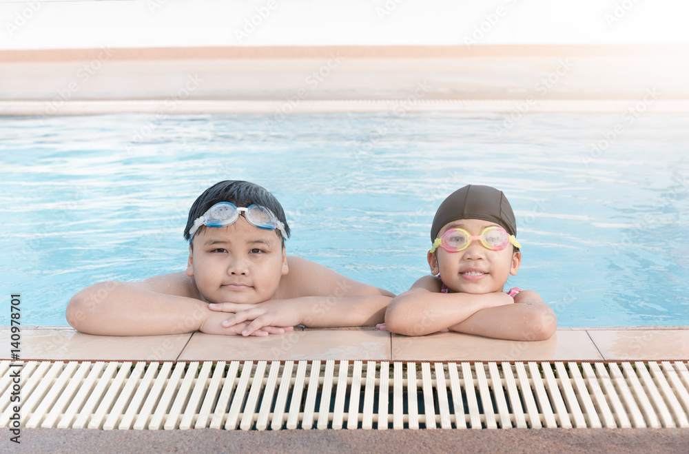cute asian girl and fat boy smile in swimming Stock Photo | Adobe Stock