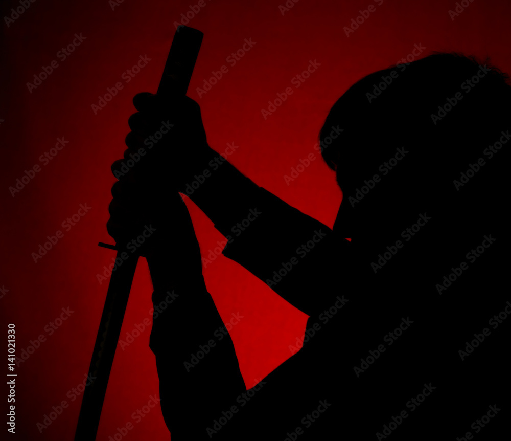 Silhouette of man with sword on red background Stock Photo | Adobe Stock