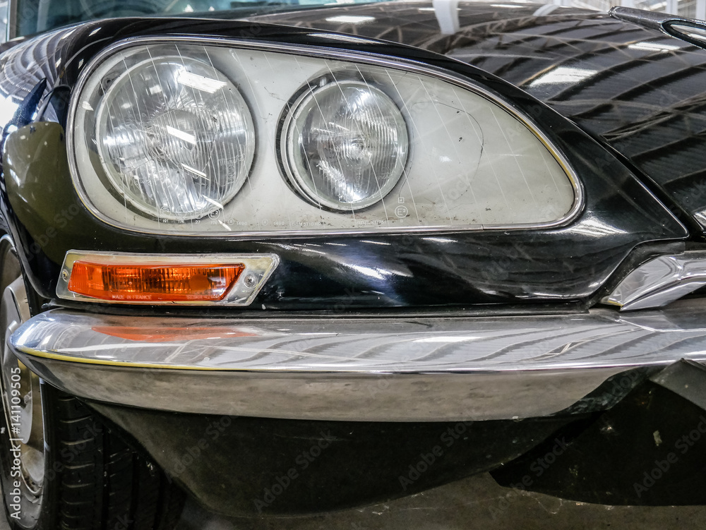 Detail of old mythic french car with big light and black sheet metal ...