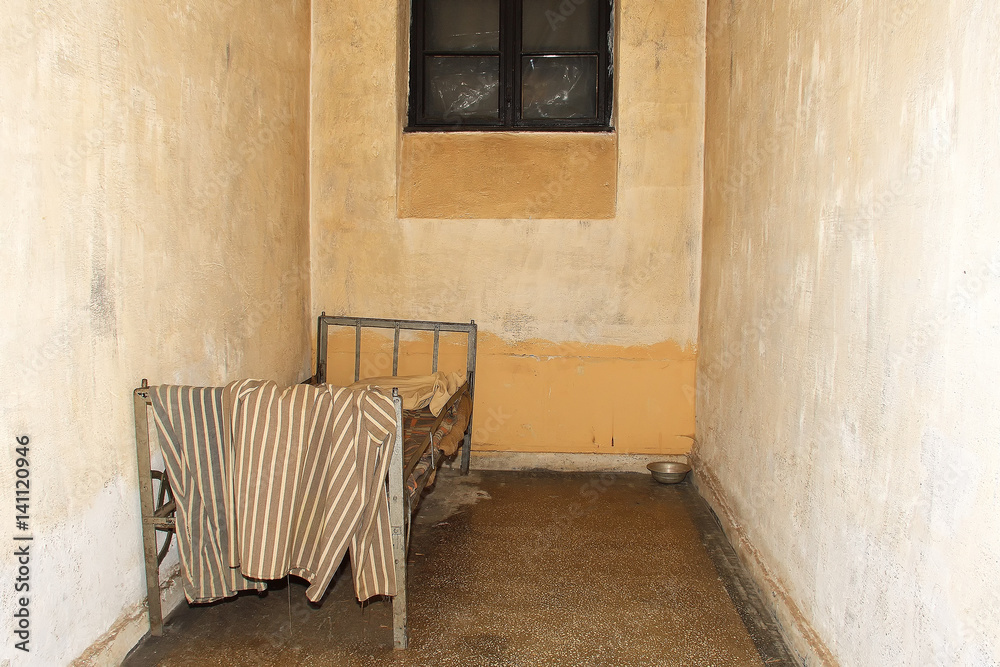 an old prison cell with a bed frame and footlocker Stock Photo | Adobe ...
