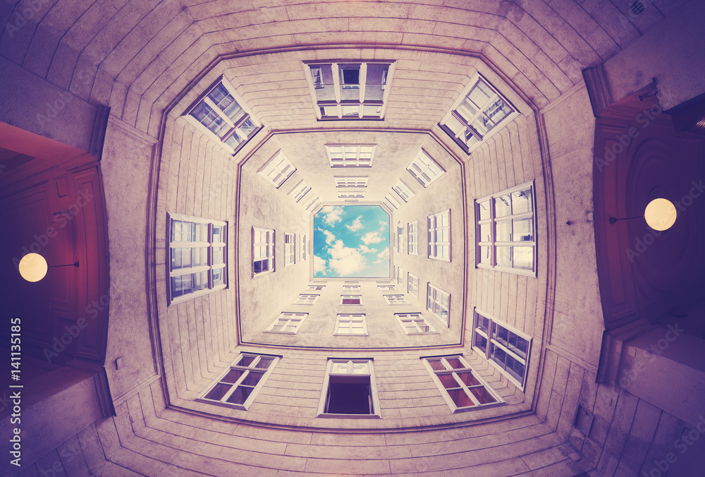 Looking up at the sky framed by a building, freedom and entrapment ...
