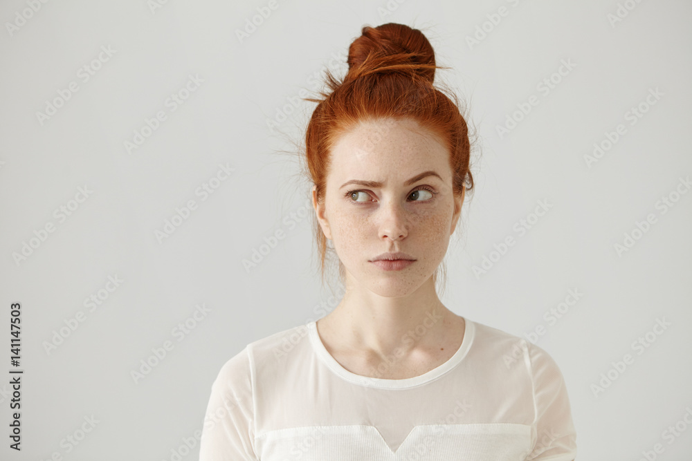 Hmm. Let me think. Studio shot of cute redhead girl with hair knot and ...