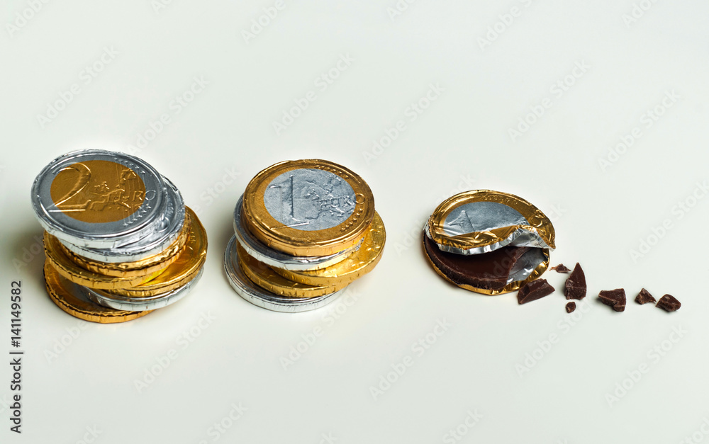 Stacked chocolate euro coins on white background, investment concept ...