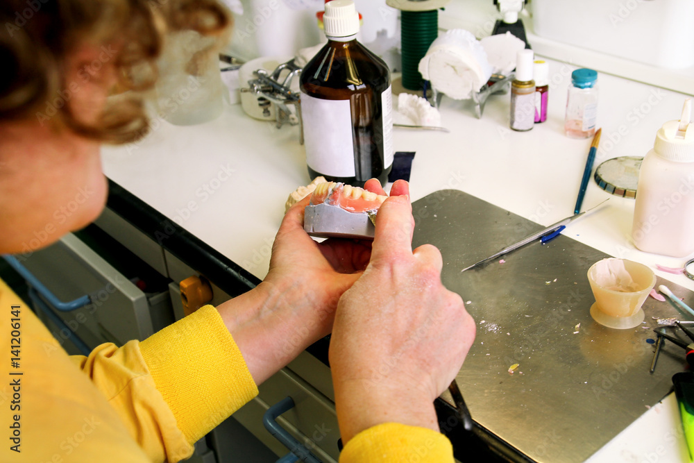Detaching a dental prosthesis form a plaster model. Dental prosthesis ...