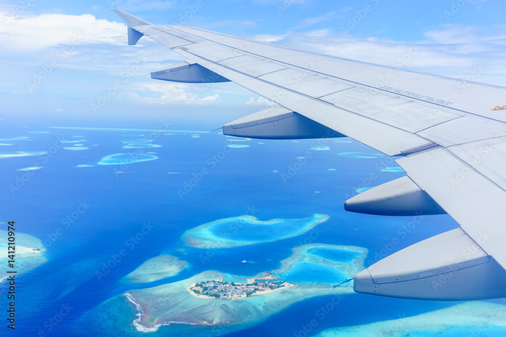 Scenery from airplane 's window seeing wing of airplane , white clouds ...