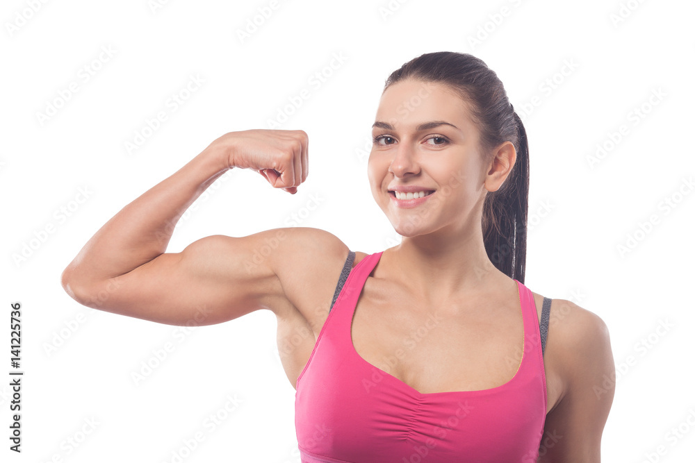 Young beautiful strong woman shows biceps and smiles. Isolated, white ...