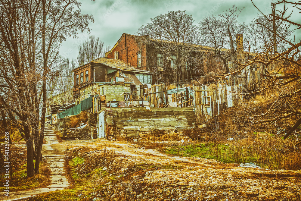 ruined house in a poor residential quarter in a slum. Noise and grain ...