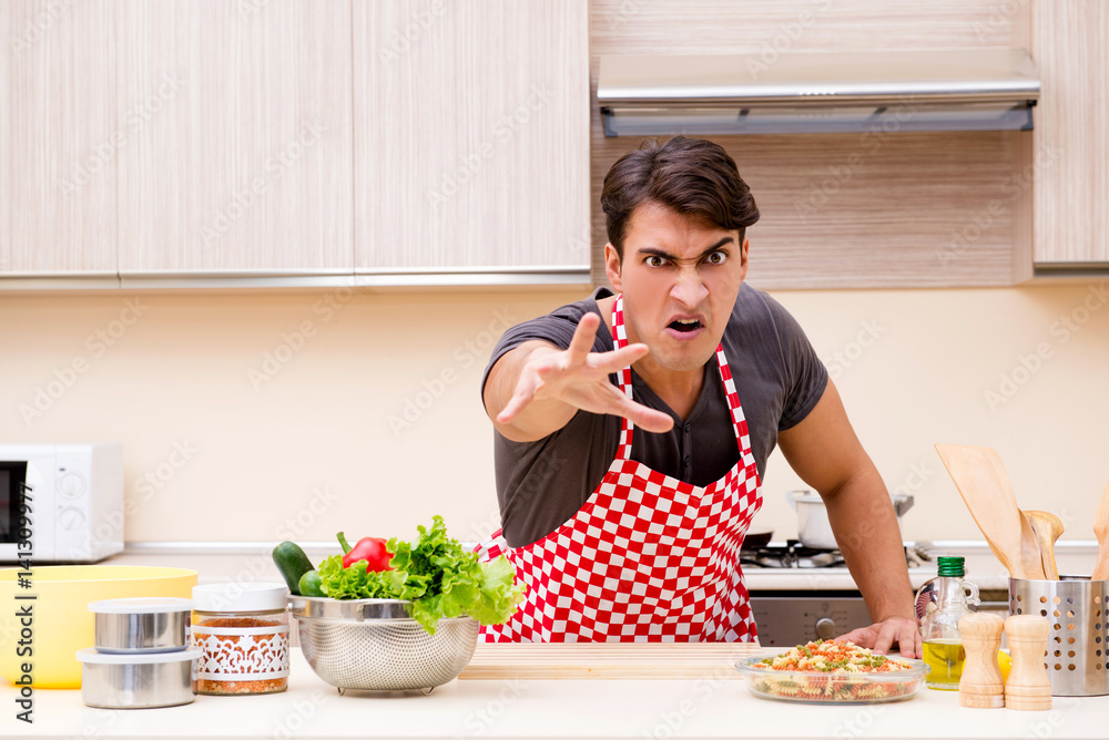 Man male cook preparing food in kitchen Stock Photo | Adobe Stock