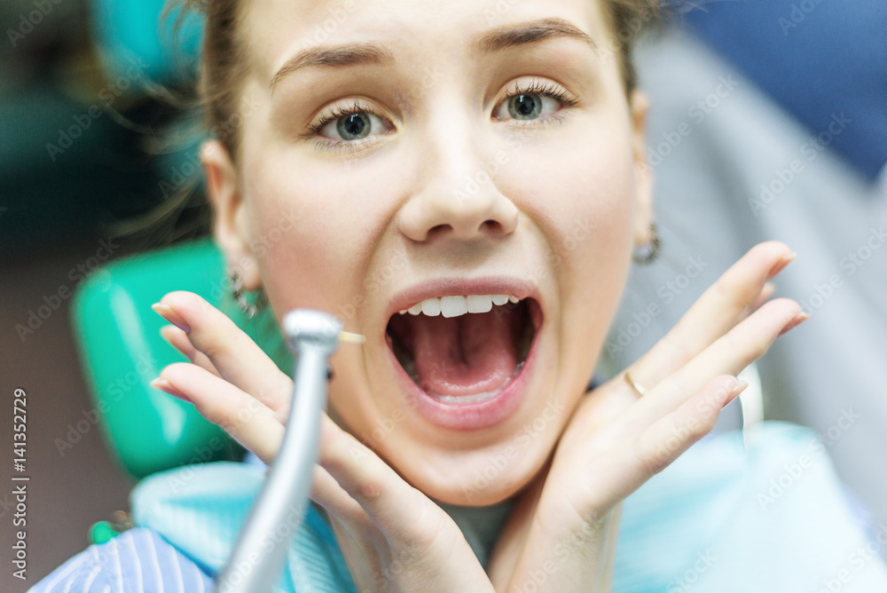 Closeup portrait young terrified girl woman scared at dentist visit ...