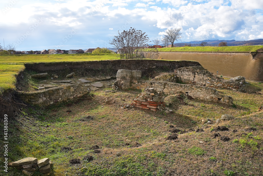 Ruins of brick fortification walls and cobblestone alleys of the ...