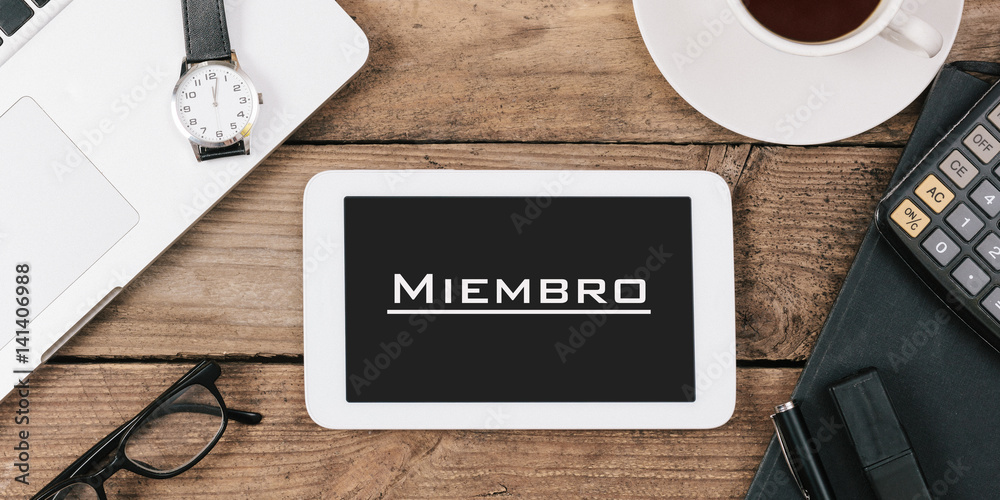 Miembro, Spanish text for Member on screen of tablet computer at office ...
