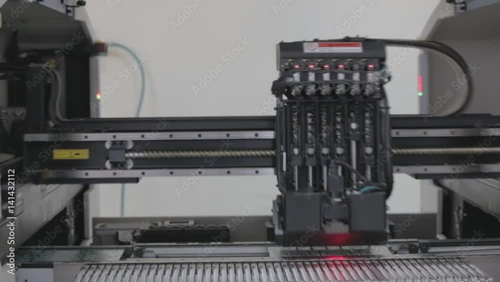 Automated Electronic circuit board production close up. Machine ...