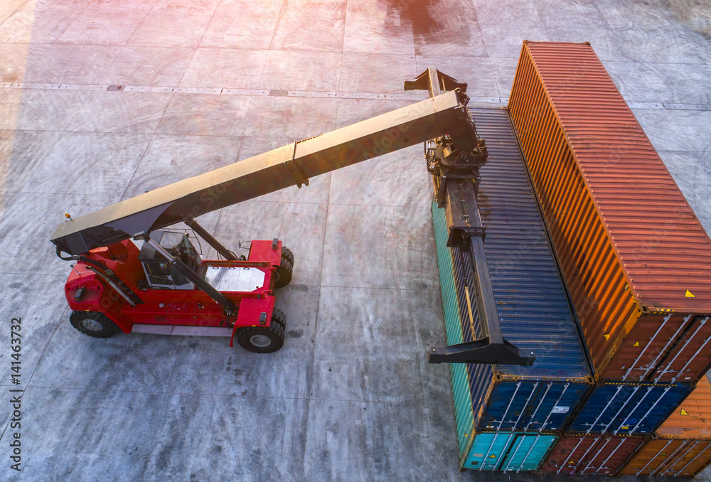container stacker forklift working on lifting unit of container in yard ...
