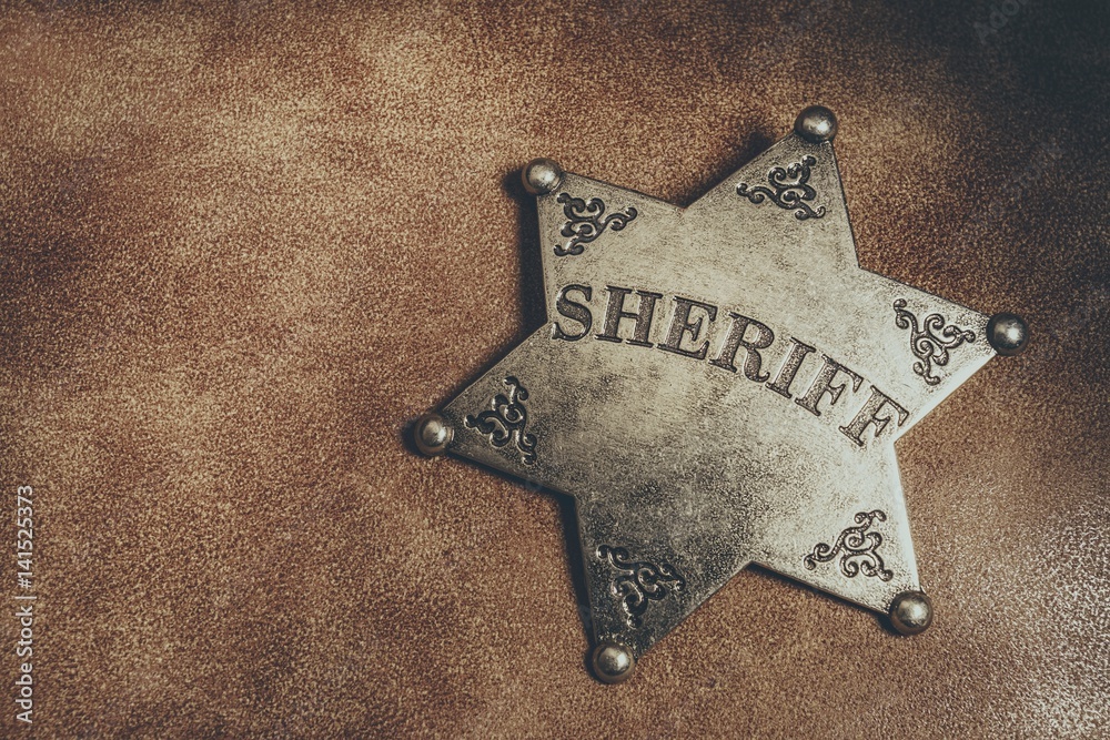 Sheriff badge on brown leather texture background. Macro shot. Stock ...