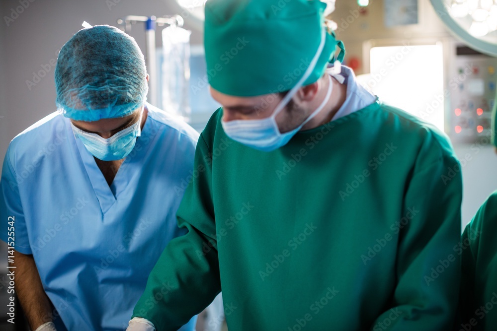 Medical team performing operation in a operating room Stock Photo ...