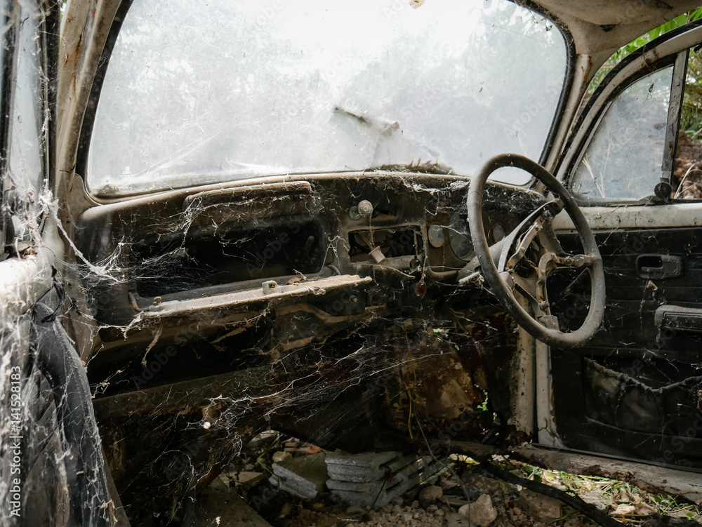 Interior of abandoned old car with spider web, damaged dashboard ...