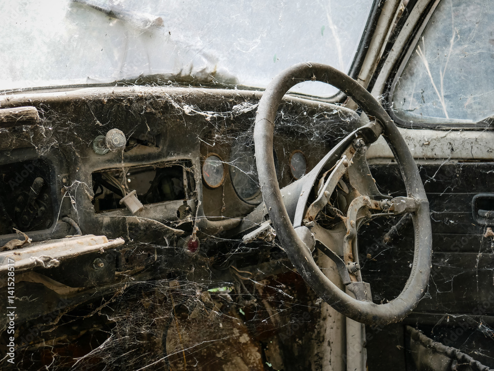 Interior of abandoned old car with spider web, damaged dashboard ...