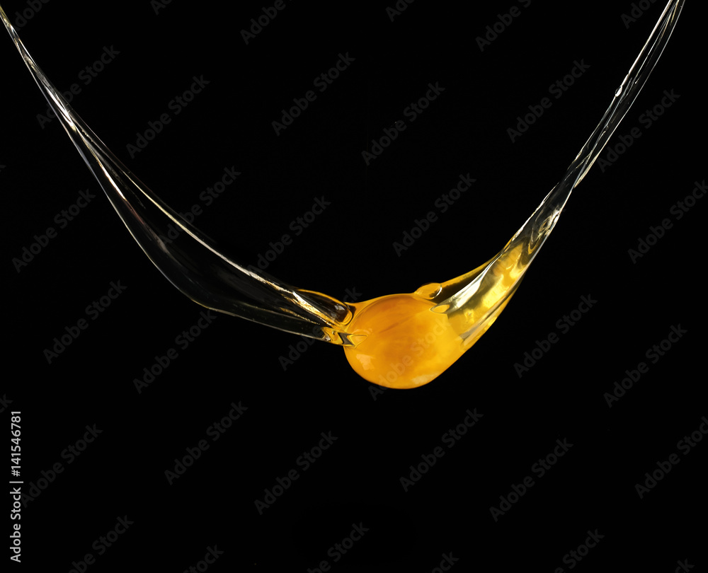 Egg yolk dripping, falling on black background. Stock Photo | Adobe Stock