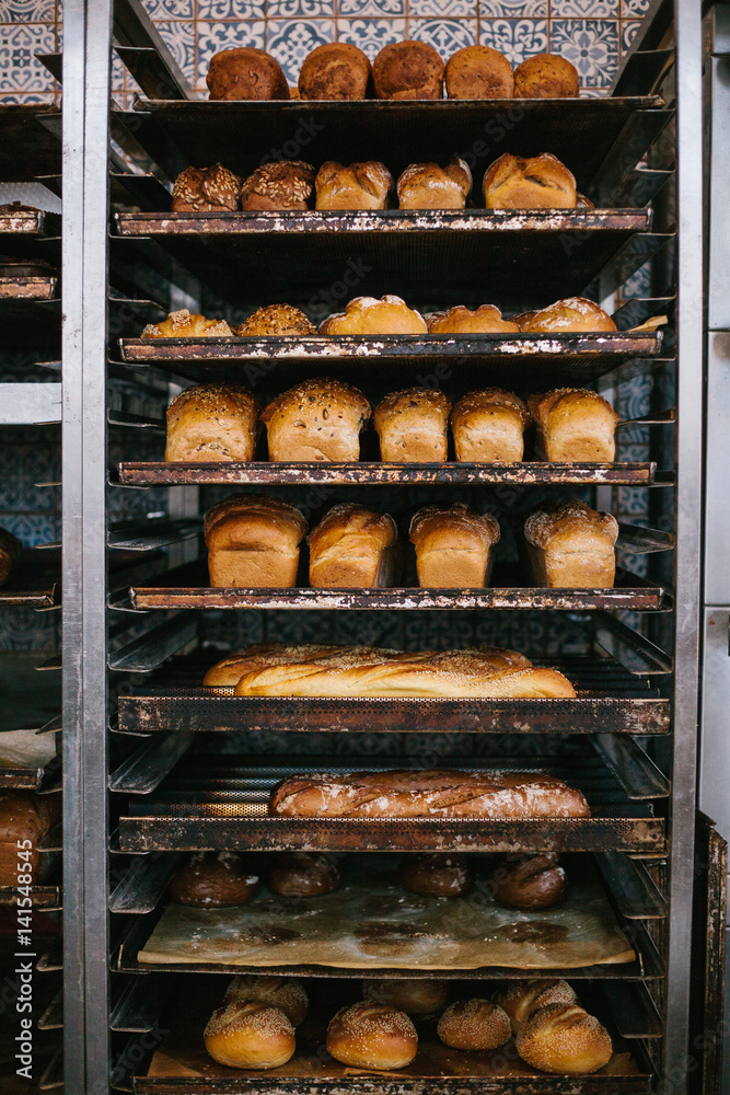 A lot of ready-made fresh bread in a bakery oven in a bakery. Bread ...
