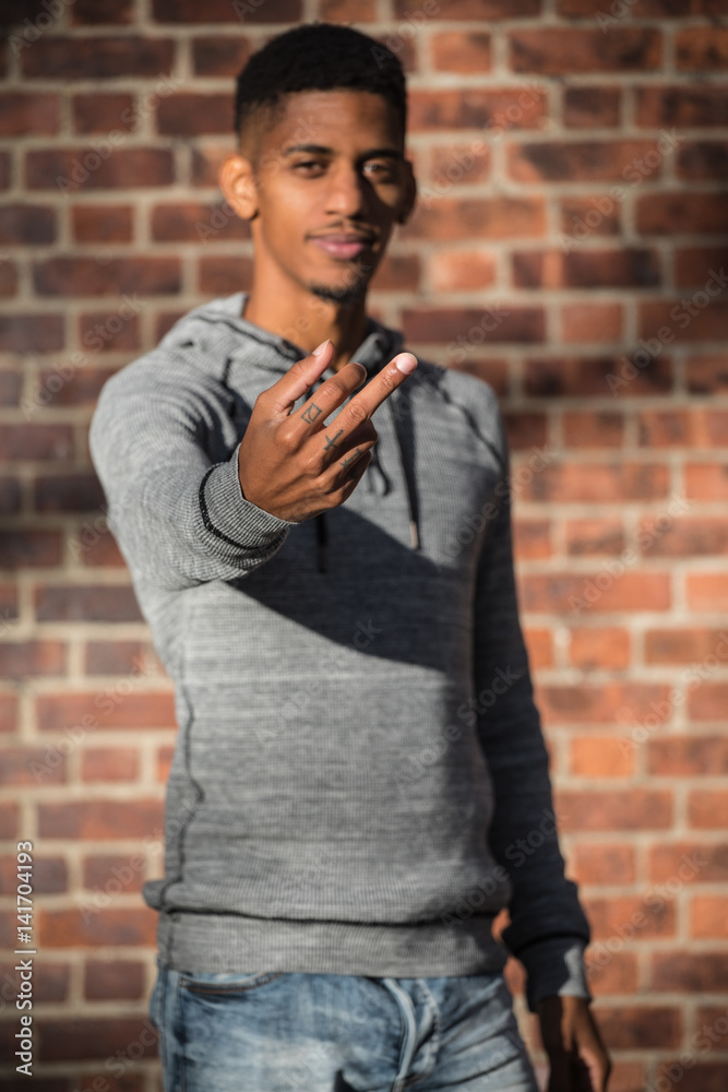 An angry, young man giving the middle finger Stock Photo | Adobe Stock