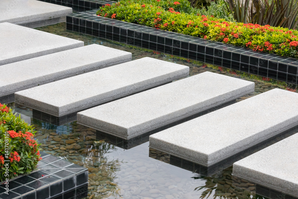 Imitation of walking on water with stone steps above the water level ...