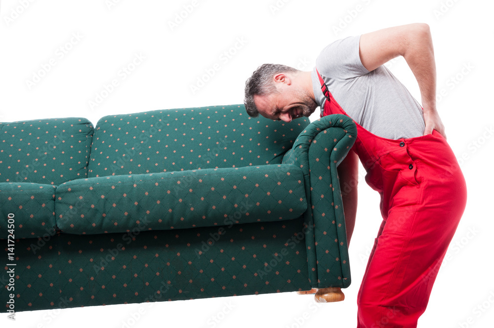 Mover guy lifting up a heavy couch having back pain Stock Photo | Adobe ...