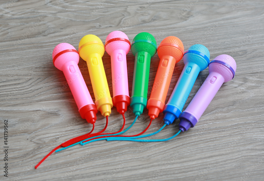 Colorful plastic microphone on wood background, Children's toy Stock ...