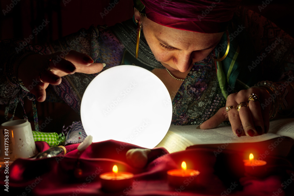 Stockfoto Gypsy woman read an old book of spells | Adobe Stock