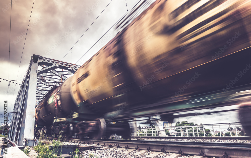 Freight train goes through the bridge , railway wagons with motion blur ...