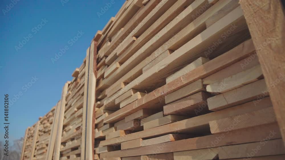 Rows of wooden bars on the street near the production area. Wooden ...