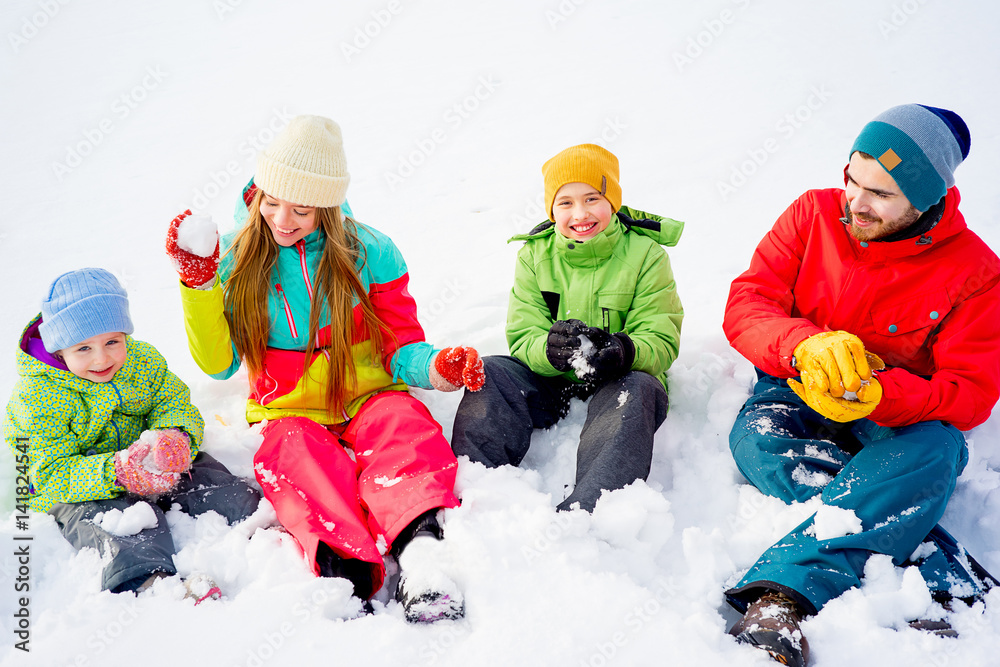 Family sitting in snow Stock Photo | Adobe Stock