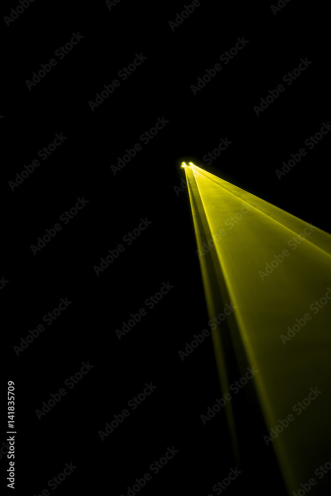 Laser beam yellow on a black background Stock Photo | Adobe Stock