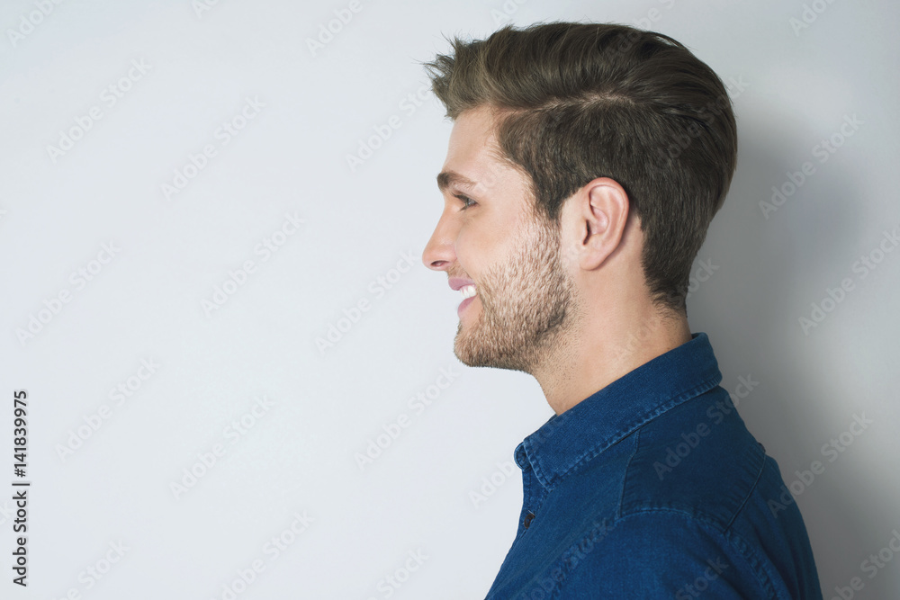 Handsome profile portrait of young smiled man. Attractive man side look ...
