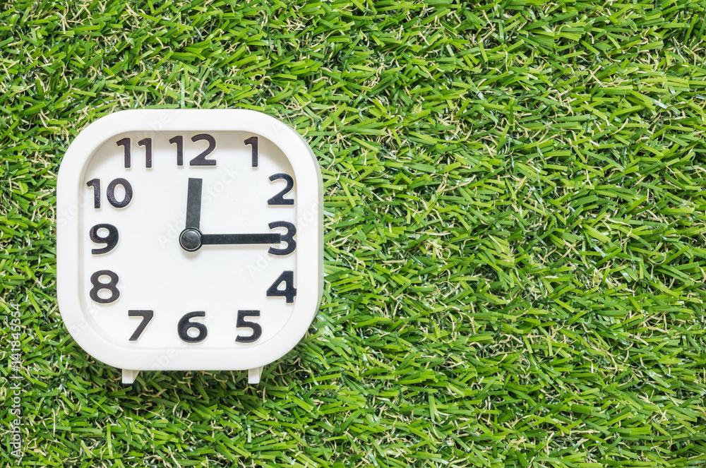 Closeup white clock for decorate show a quarter past twelve o'clock or ...