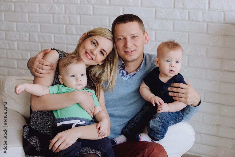 Happy family portrair. Parents with baby two boys twins.Portrait of ...