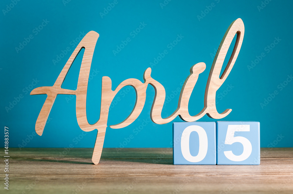 April 5th. Day 5 of month, daily calendar on desk with blue background ...