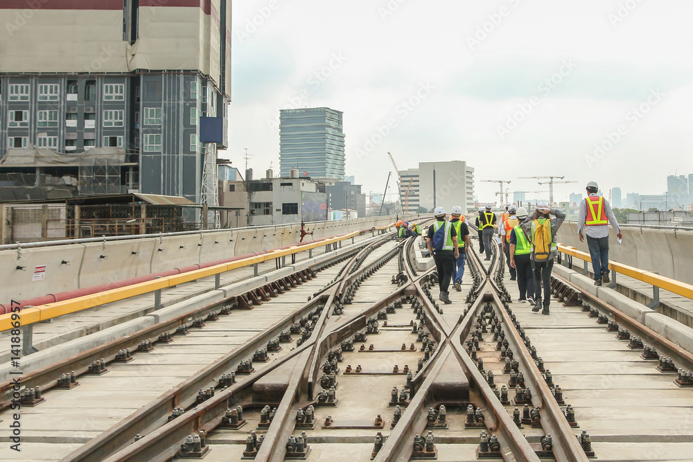 Engineer walk on track or railway on viaduct of sky train for inspect ...
