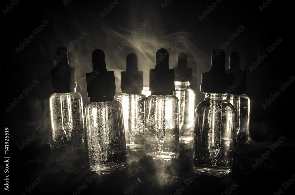 Vape concept. Smoke clouds and vape liquid bottles on dark background ...