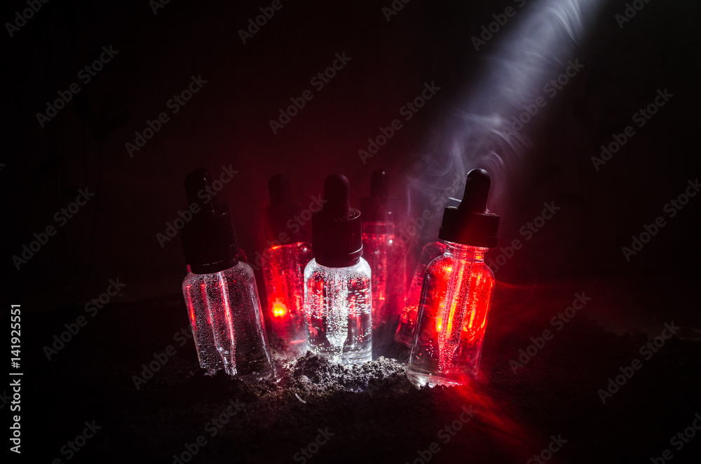 Vape concept. Smoke clouds and vape liquid bottles on dark background ...