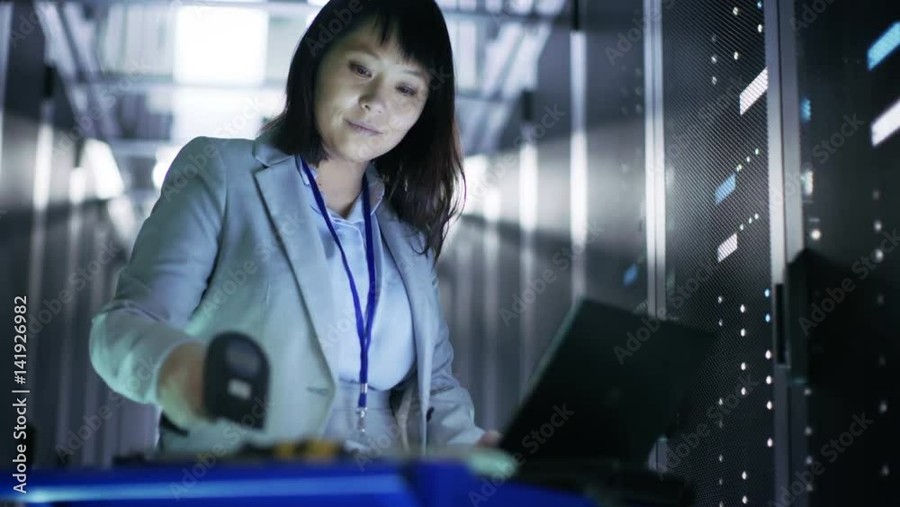 Asian Female IT Engineer Working on a Crash Cart Laptop, She Scans Hard ...