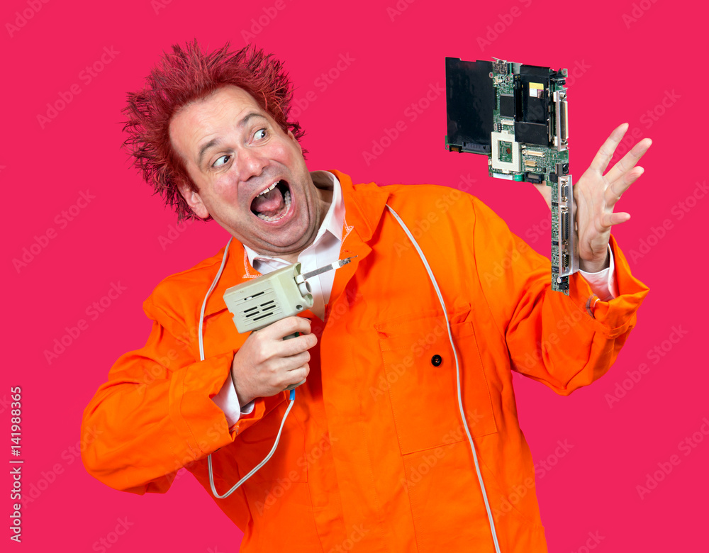 Man with solder repairs motherboard. Repairman with tools servicing the ...