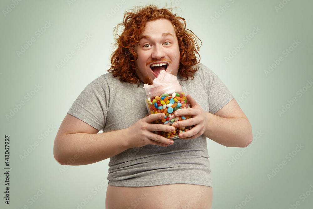 Excited happy obese young man with ginger curly hair opening mouth ...