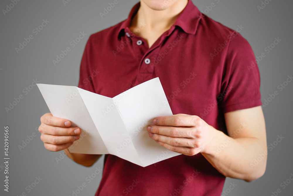 Man reading blank white flyer brochure. Read detailed booklet. Leaflet ...