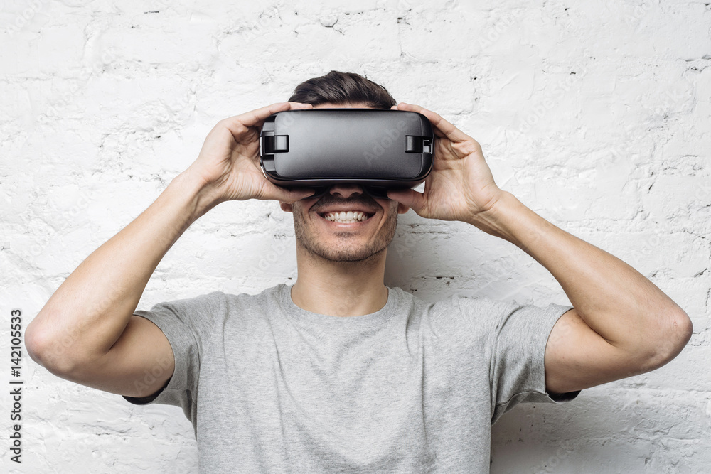 Close up portrait of handsome man playing video games in goggles or 3d ...
