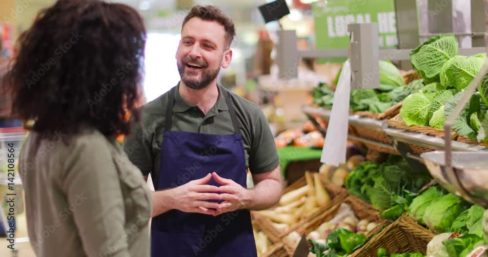 Shop assistant in grocery store helping shopper Stock Video | Adobe Stock