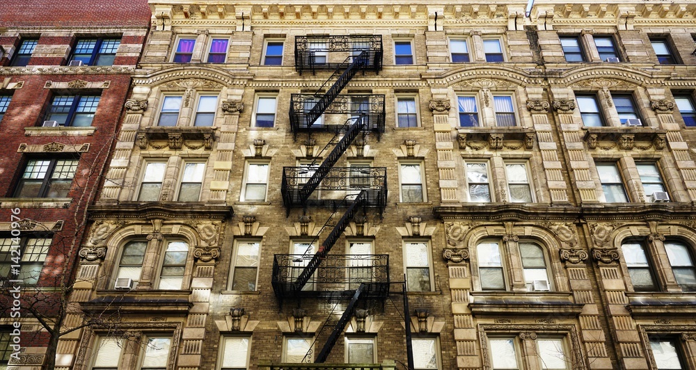 Fire escape stairs emergency exits on the outside of old buildings in ...