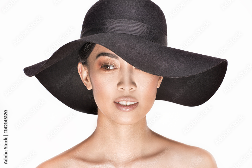 Fashionable young asian girl in hat. Stock Photo | Adobe Stock