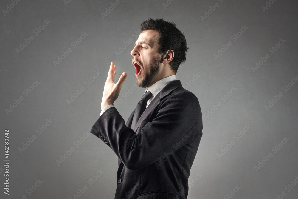 Tired businessman yawning Stock Photo | Adobe Stock