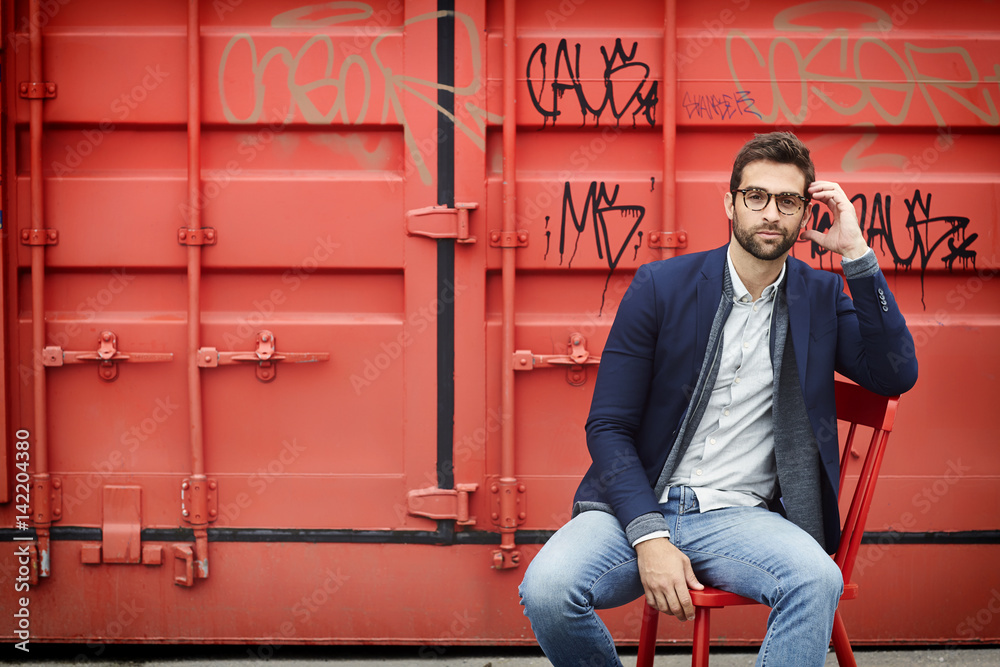 Cargo container guy sitting, portrait Stock-Foto | Adobe Stock