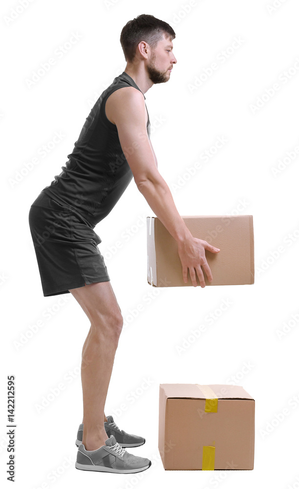 Posture concept. Man lifting heavy cardboard box against white ...